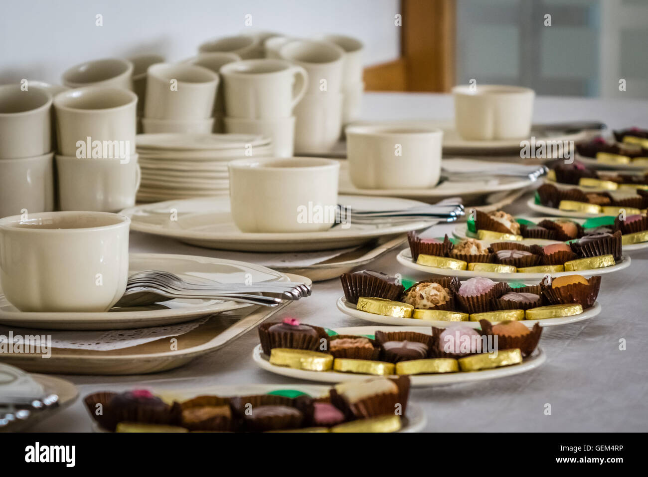 Anniversary event reception table with mints and sweets and coffee cups ...