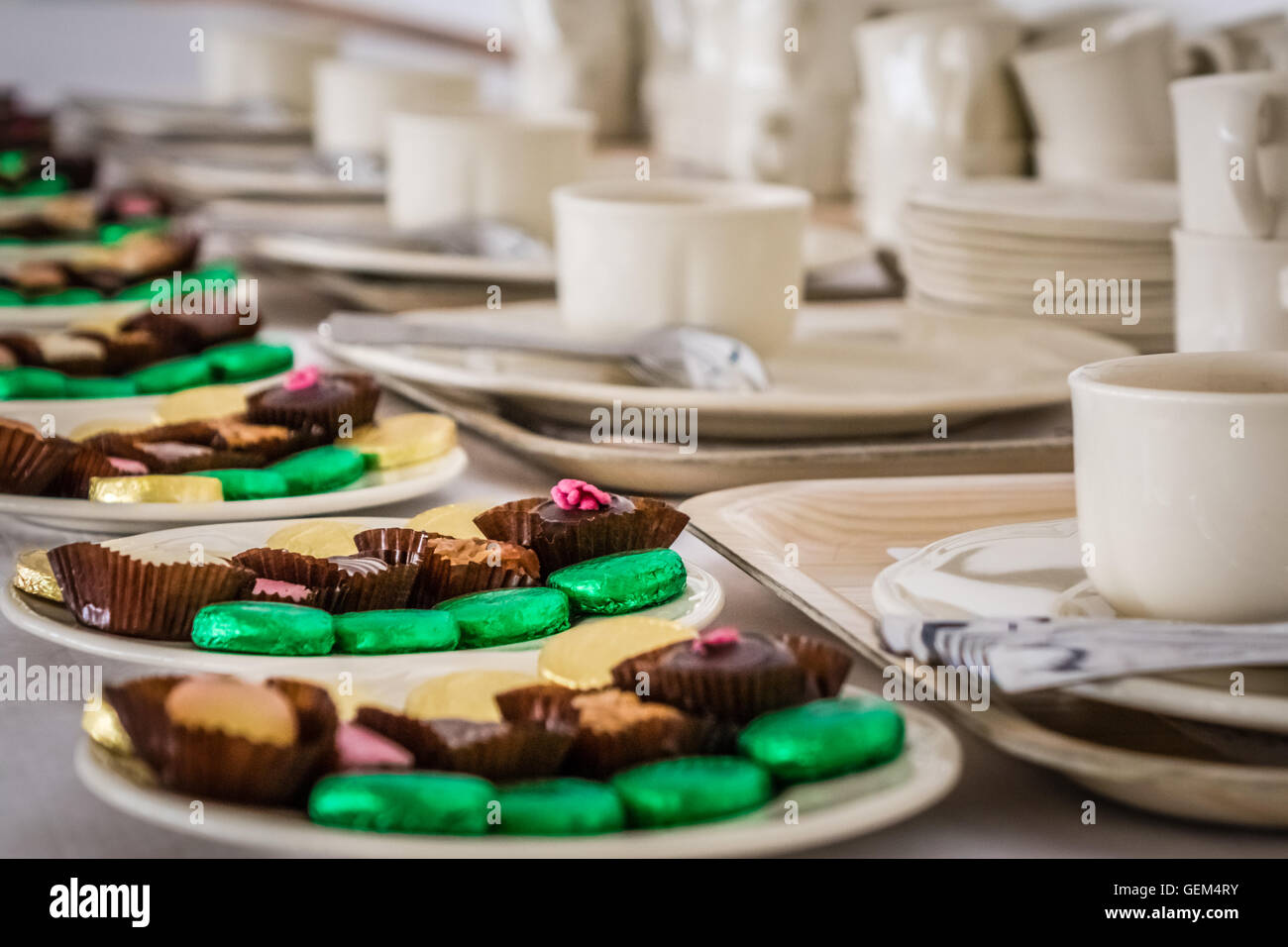 Anniversary event reception table with mints and sweets and coffee cups ...