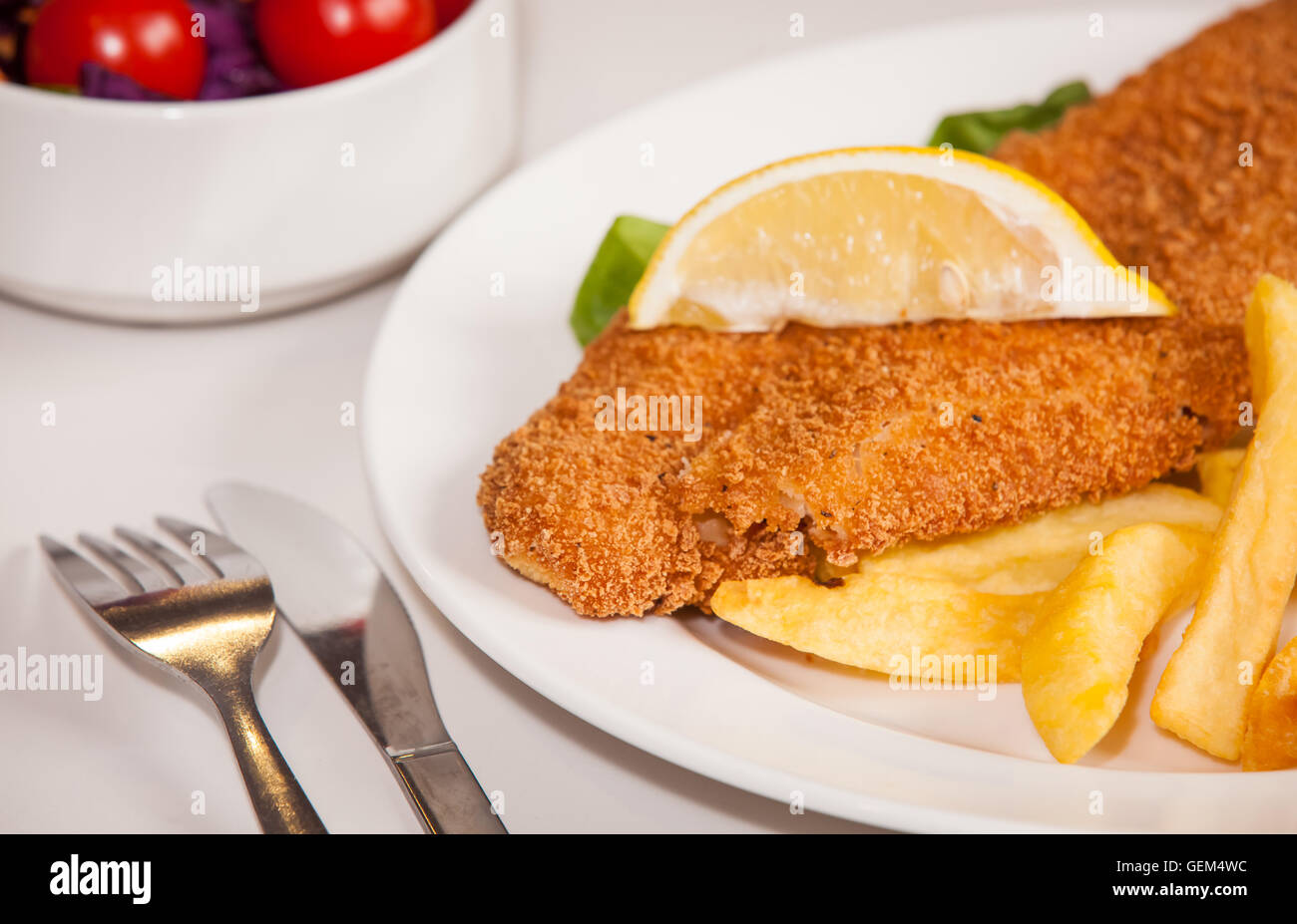 Gourmet fish and chips meal served with side salad Stock Photo - Alamy