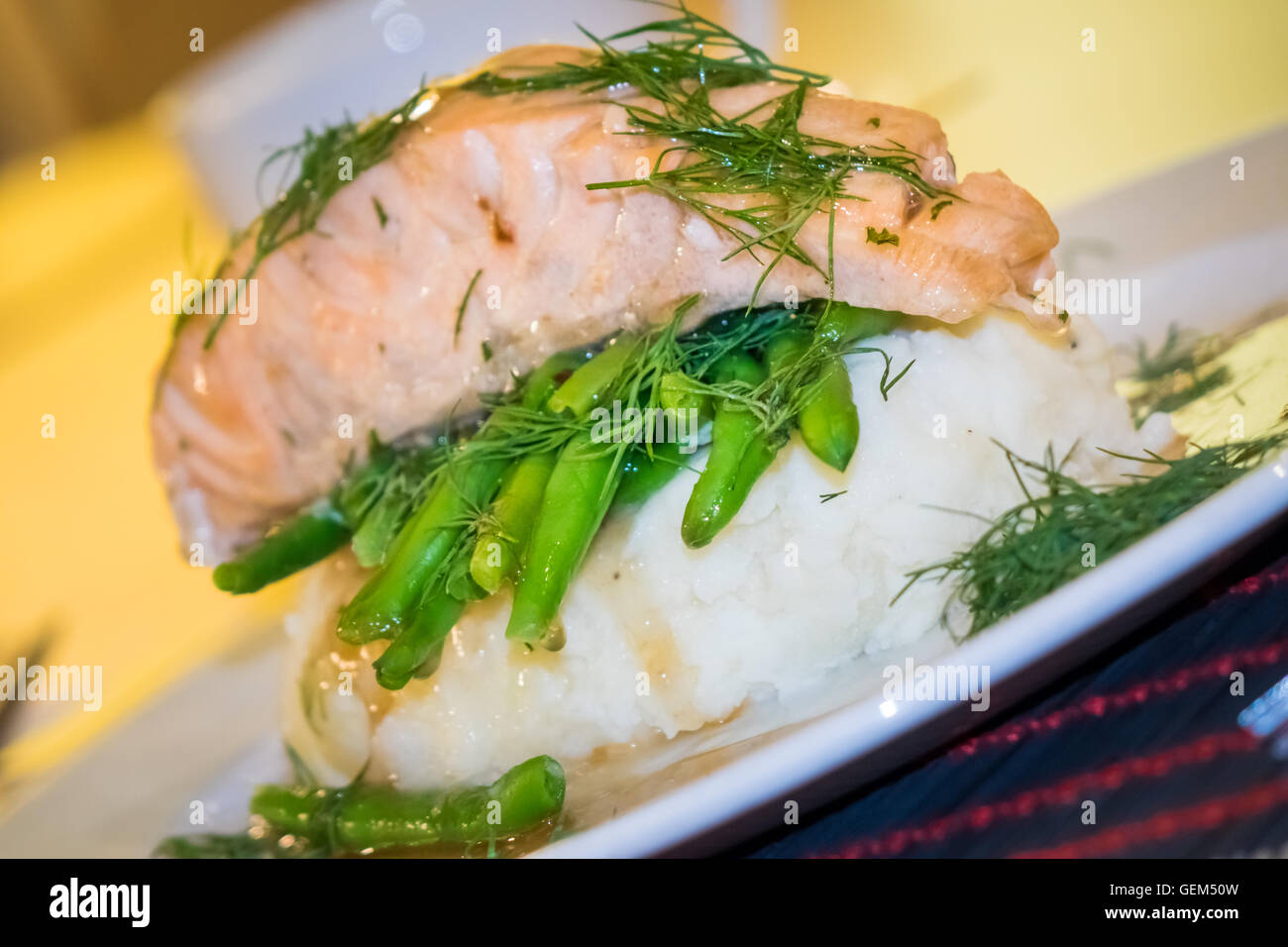Roast salmon main course served with mashed potatoes and green beans ...
