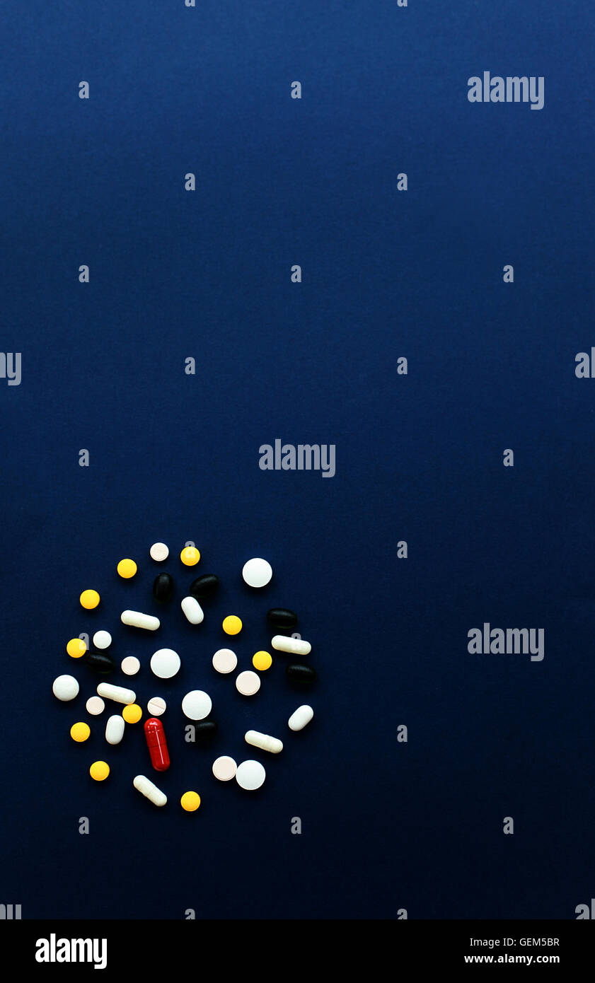 Mixture of tablets in the shape of a circle on a black background Stock ...