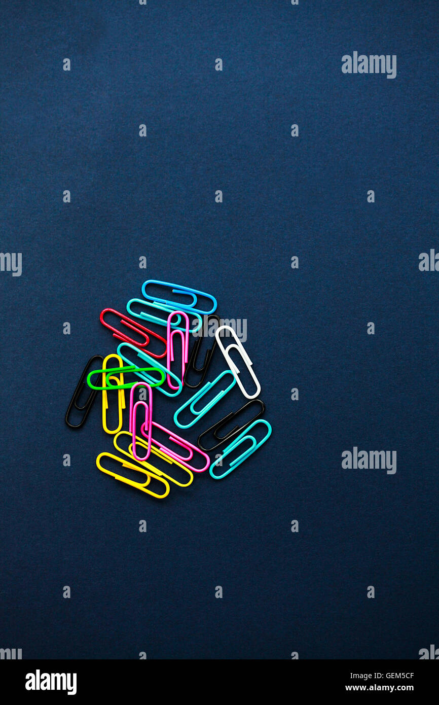 Multi coloured paper clips on plain background Stock Photo - Alamy