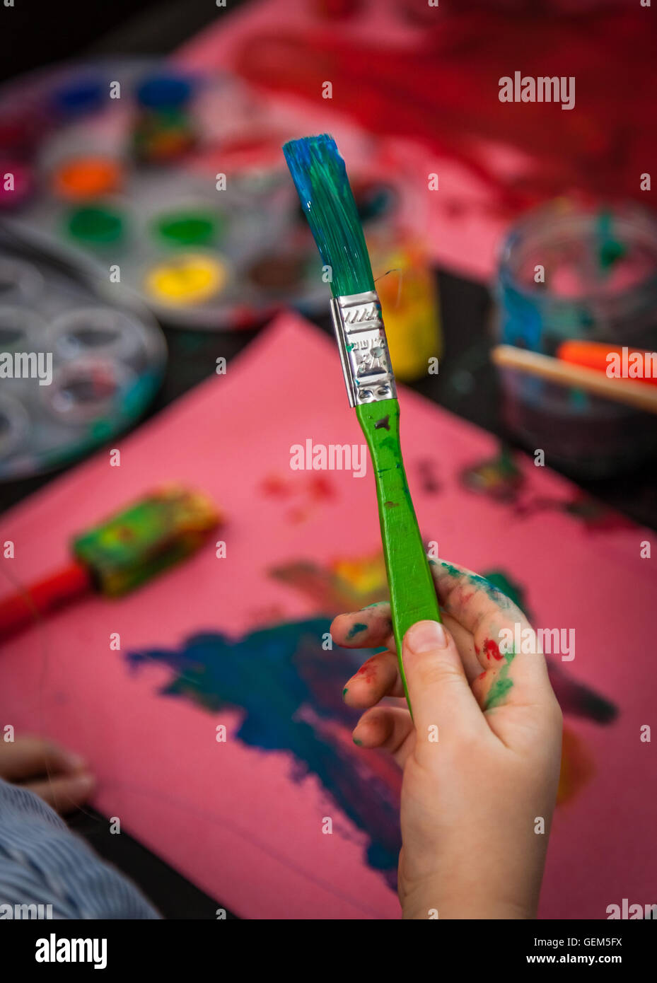Child hand holding dirty brush used for painting pictures at home Stock ...