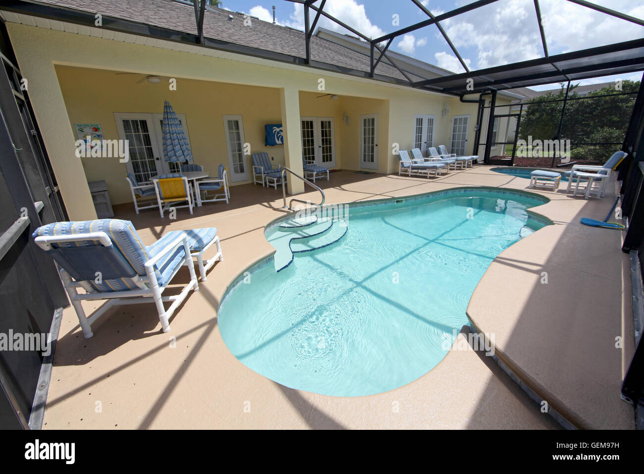 A Swimming Pool, Spa and Lanai with chairs Stock Photo - Alamy