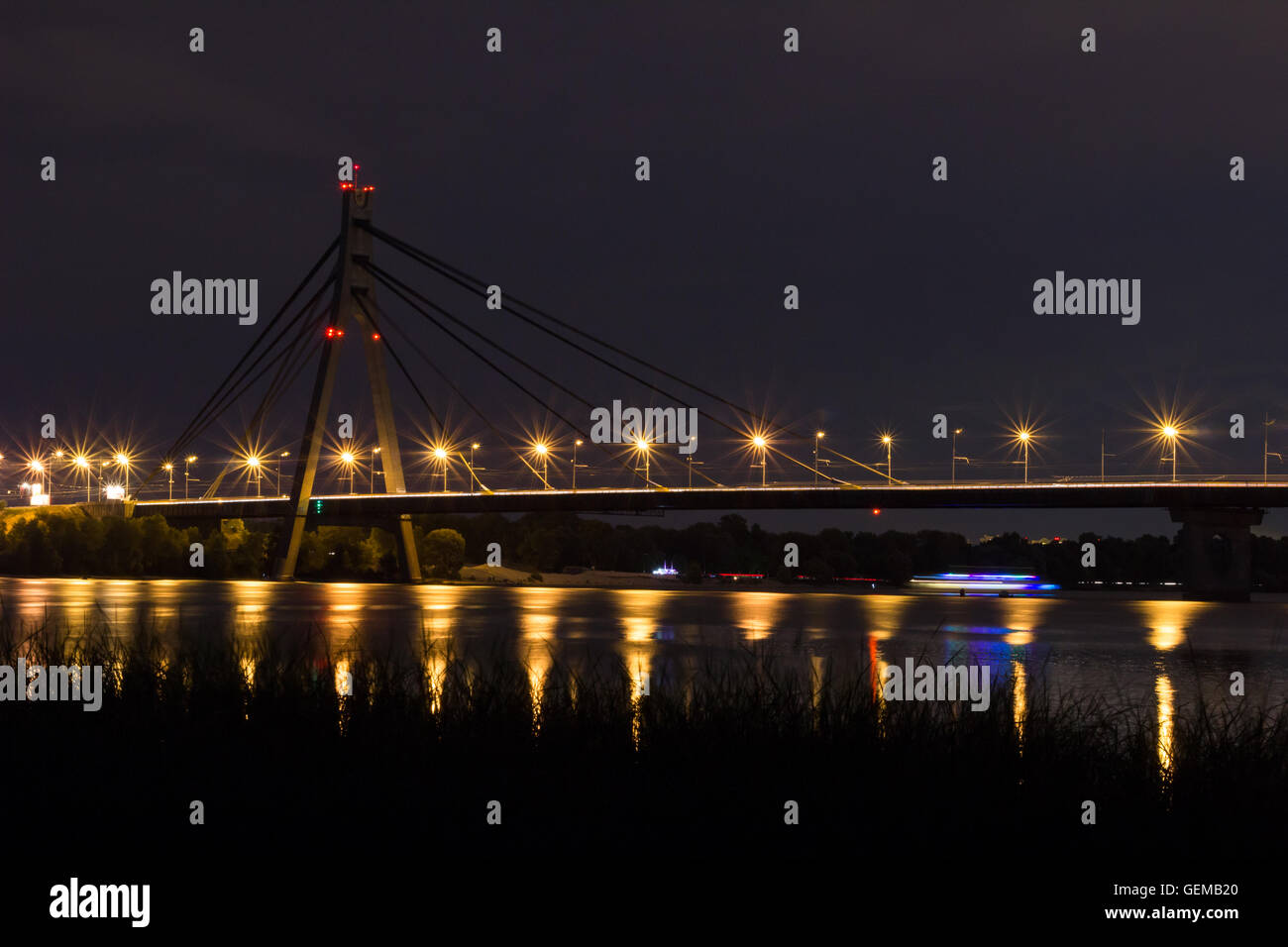 Night bridge above river with reflecting lights Stock Photo - Alamy