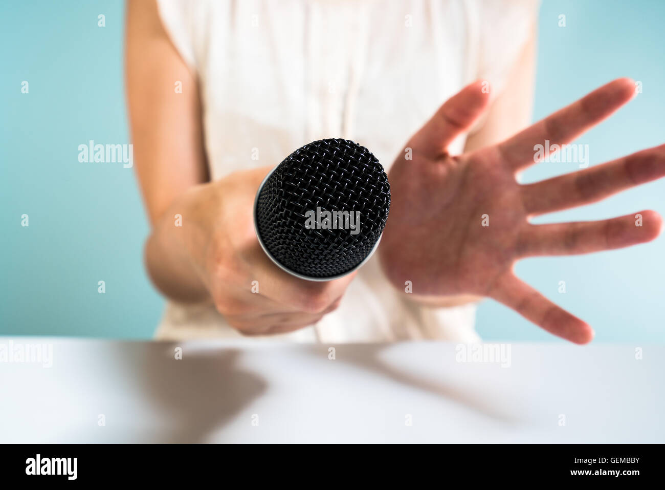 Woman holding microphone Stock Photo - Alamy