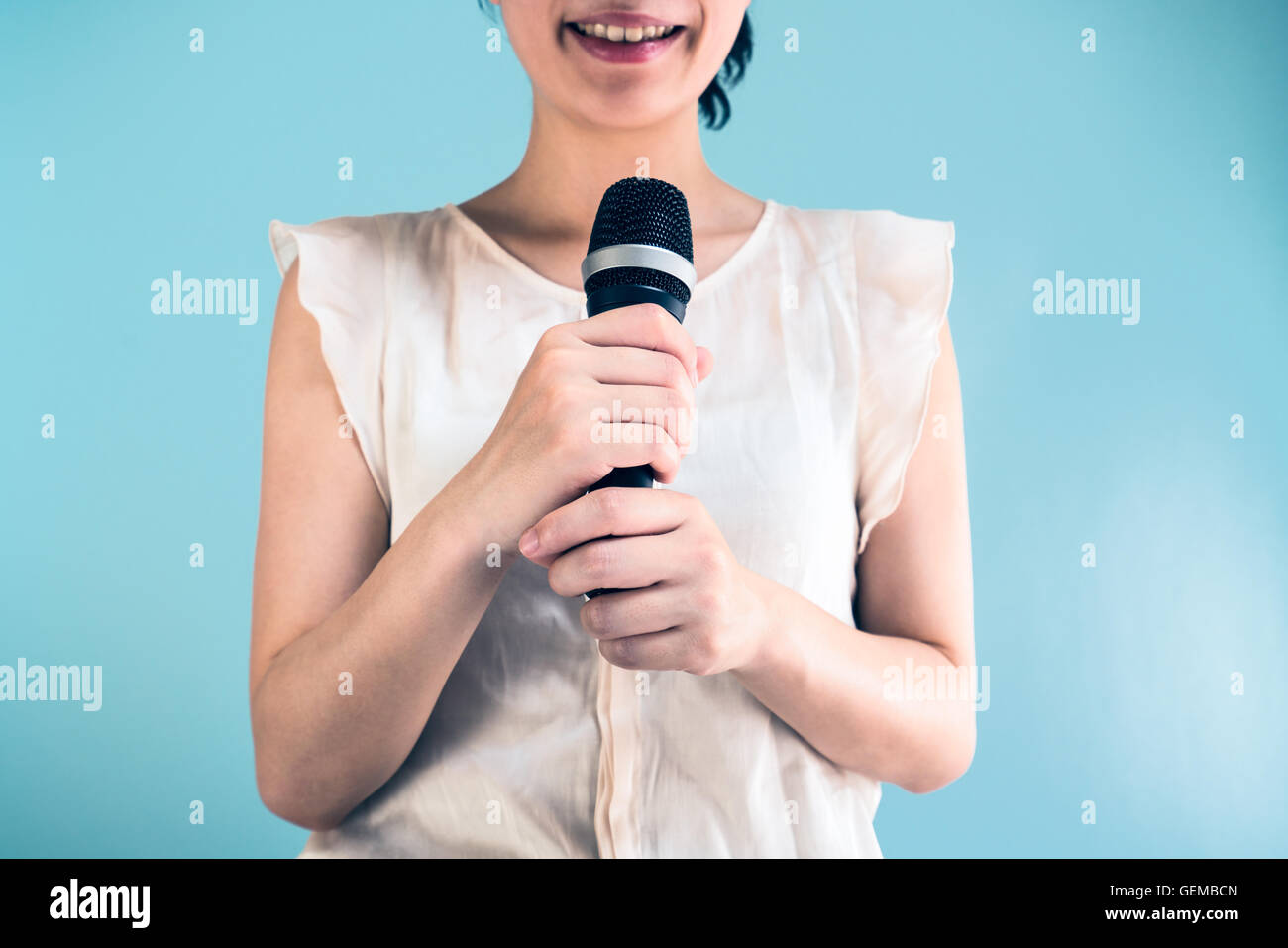 Woman holding microphone Stock Photo - Alamy