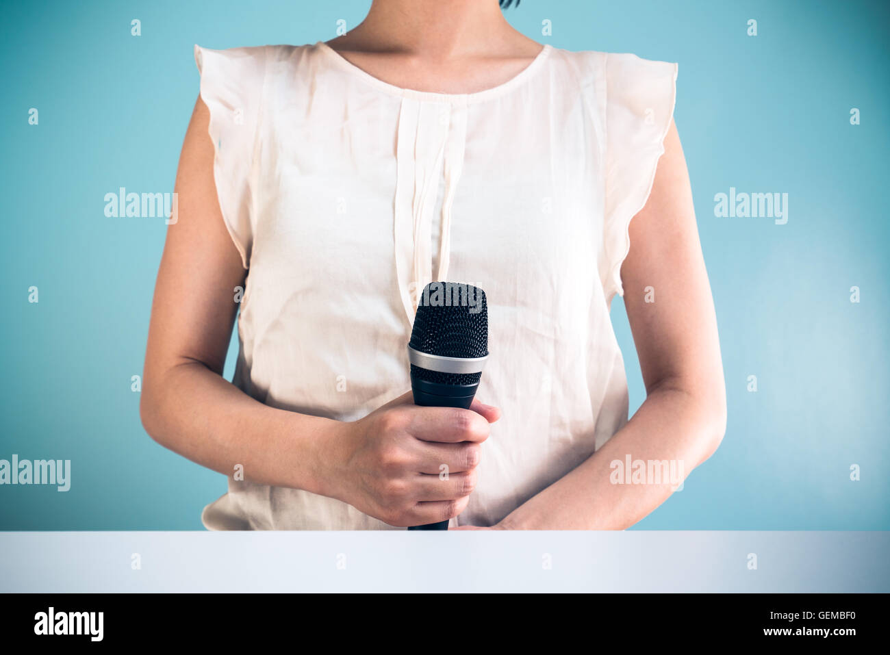 Woman holding microphone Stock Photo - Alamy