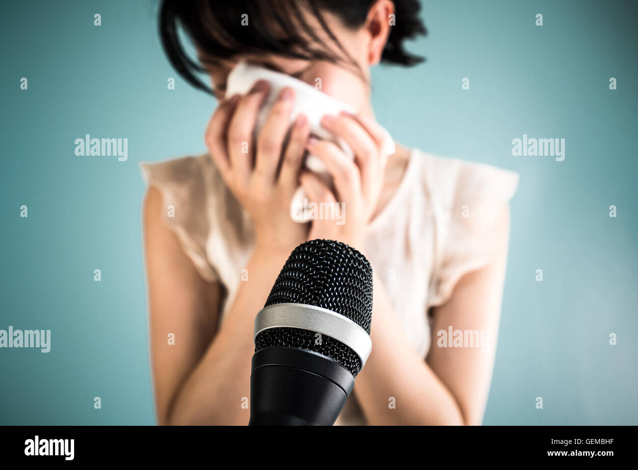 Woman crying at a press conference Stock Photo - Alamy