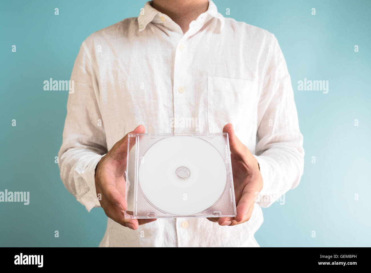 Man holding DVD-ROM Stock Photo - Alamy