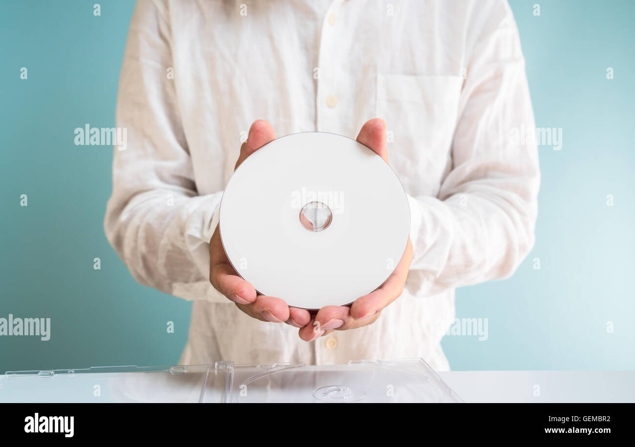Man holding DVD-ROM Stock Photo - Alamy