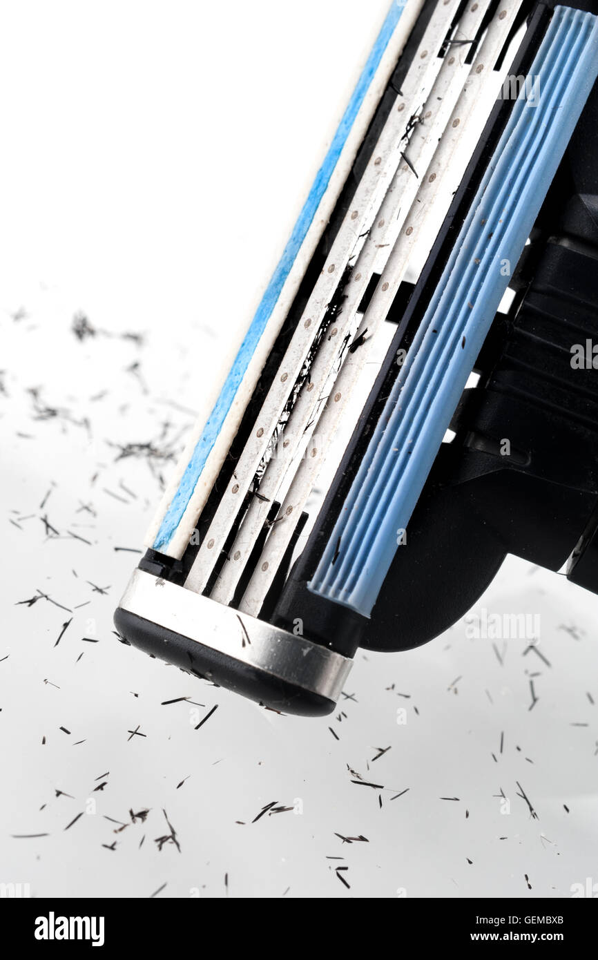 closeup used multiple blade razor on white background Stock Photo - Alamy