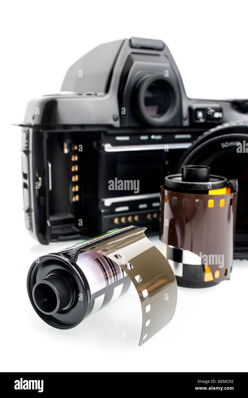 closeup camera film and black camera with opened back lid on white ...