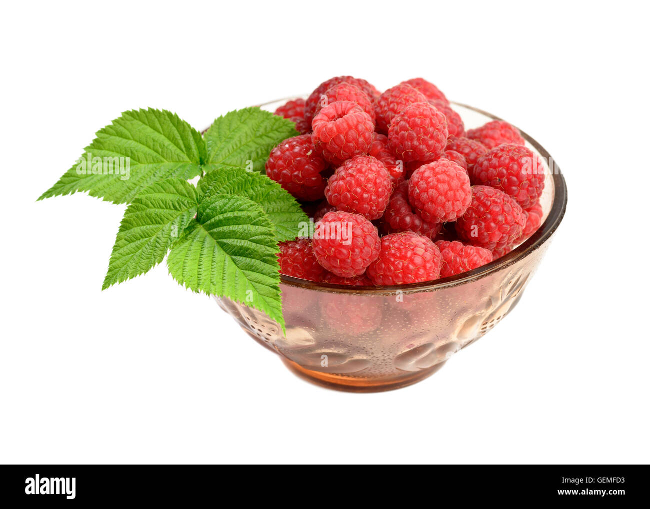 Ripe raspberry with leaf at bowl on white background Stock Photo - Alamy