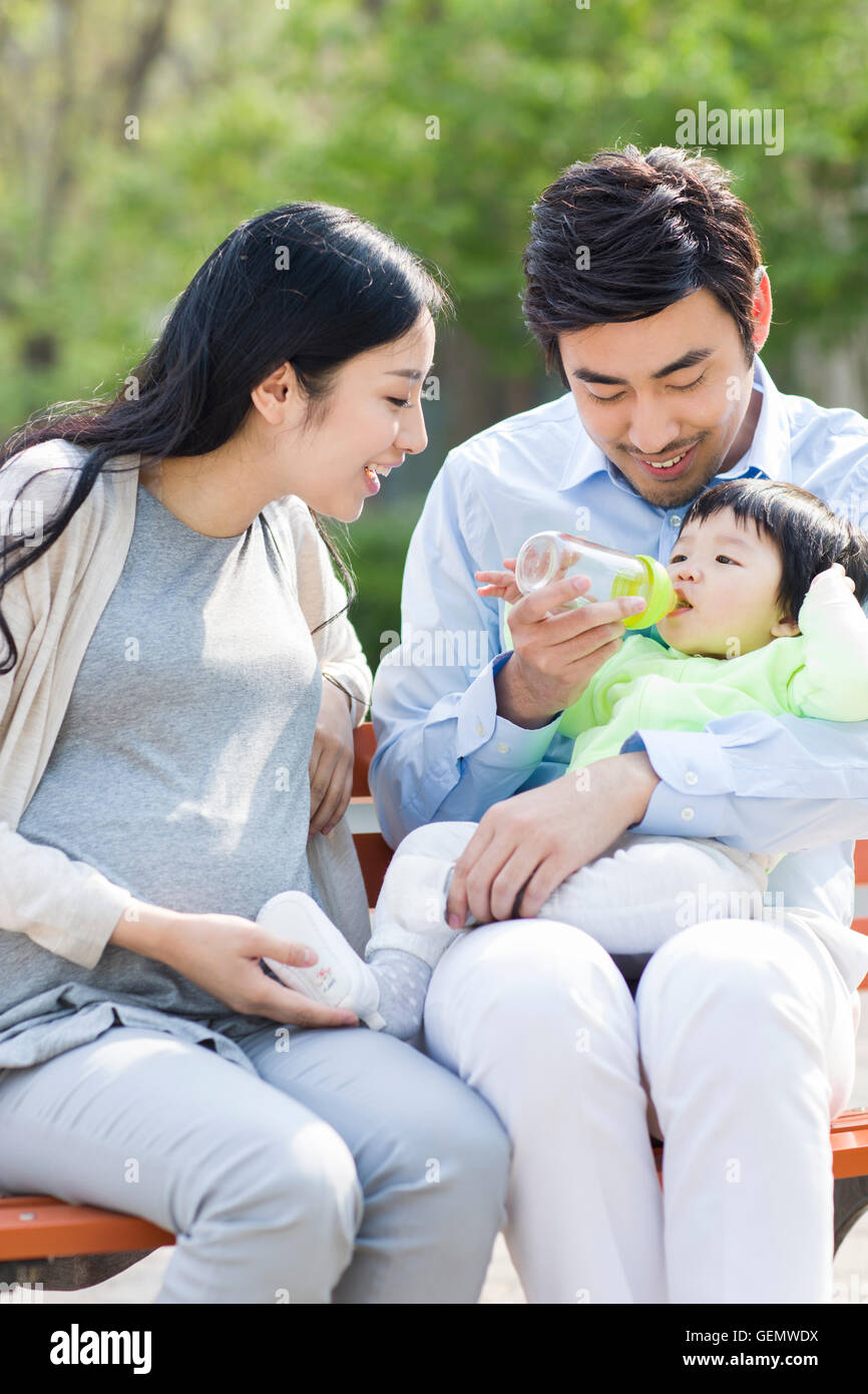 Young Chinese parents feeding their baby Stock Photo - Alamy