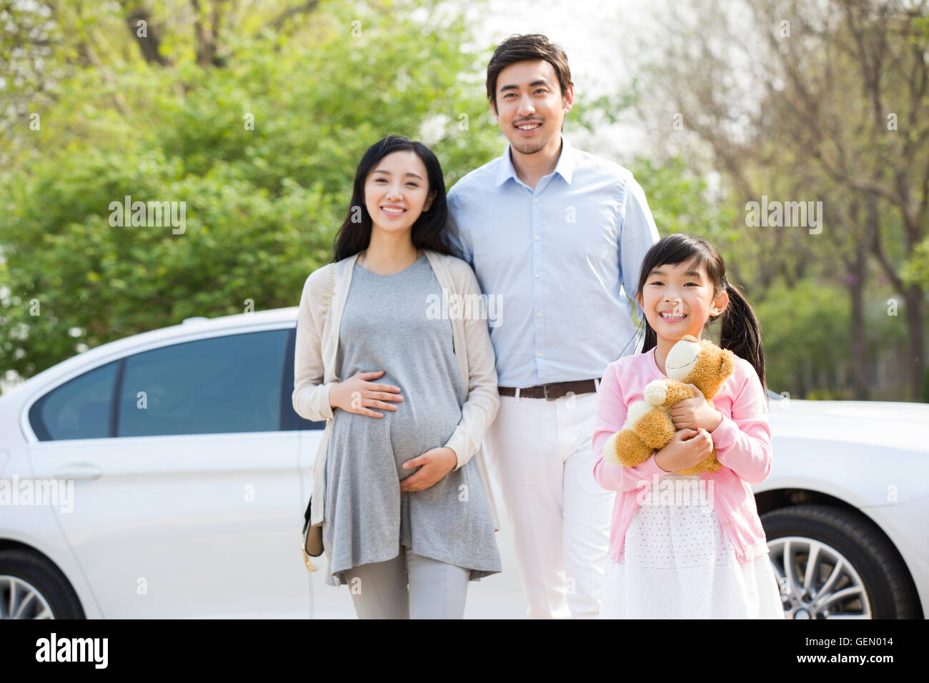 Happy young Chinese family and car Stock Photo - Alamy