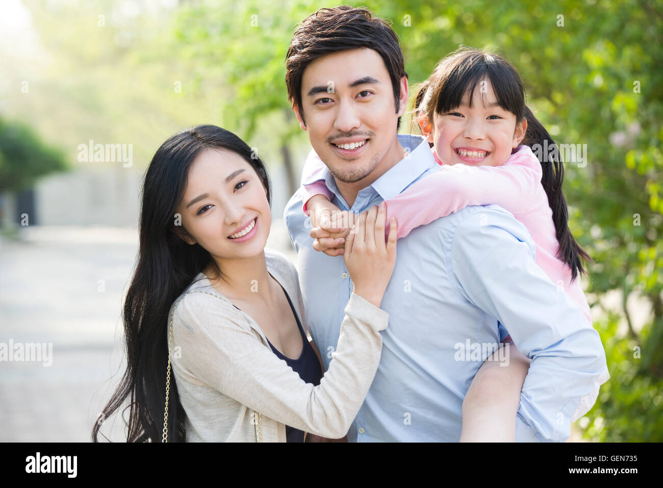 Portrait of happy young Chinese family Stock Photo - Alamy