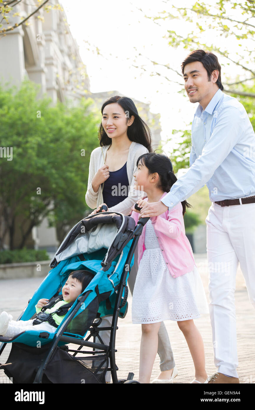 Young Chinese family taking a walk with baby in pram Stock Photo - Alamy