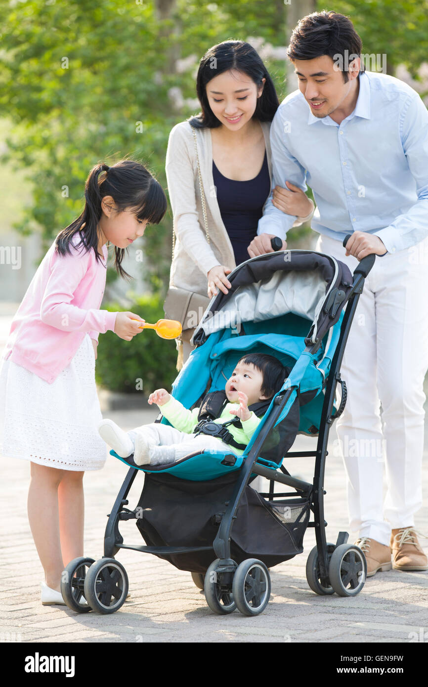 Young Chinese family taking a walk with baby in pram Stock Photo - Alamy