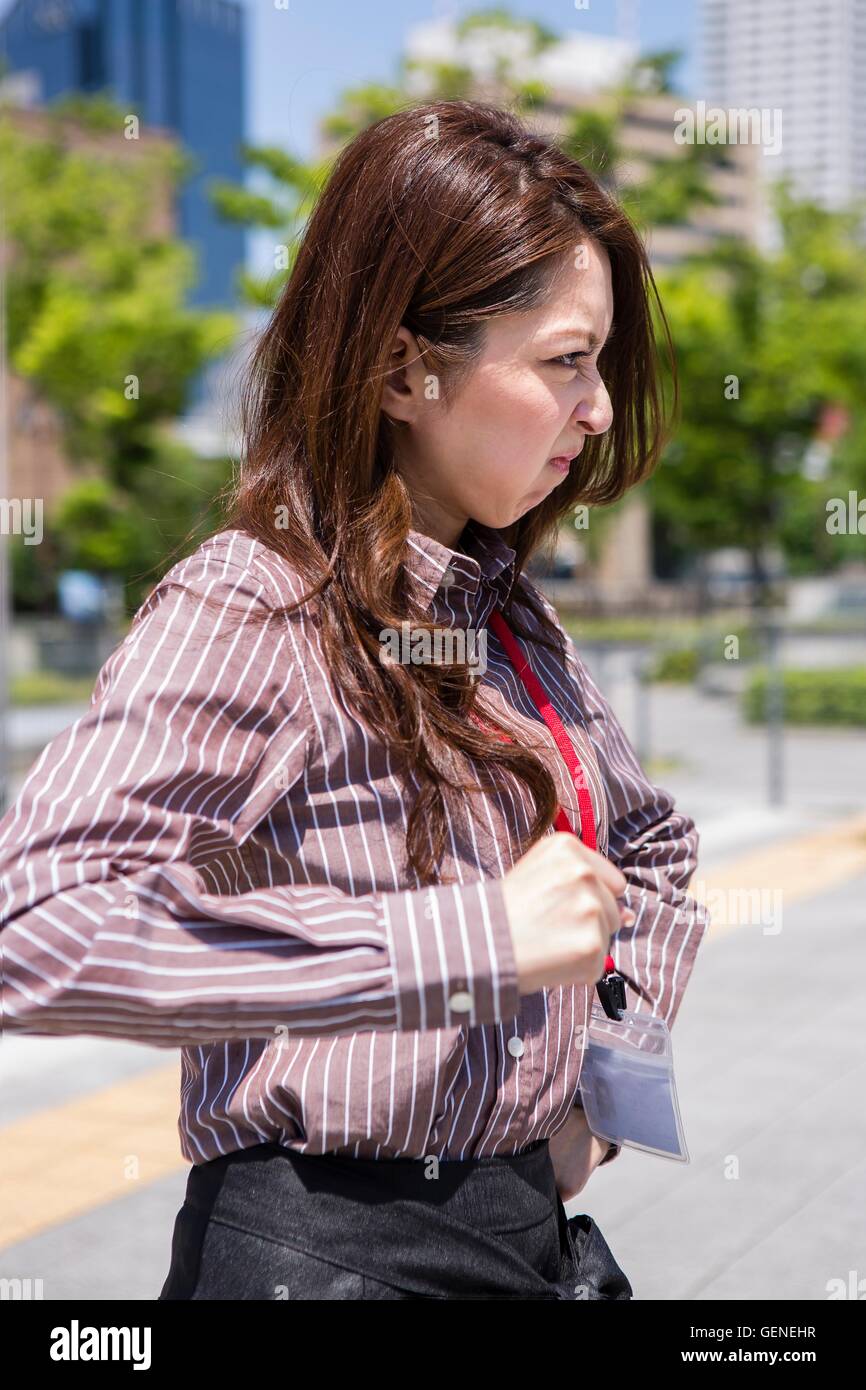 Business woman being angry and the another woman covering her ears ...