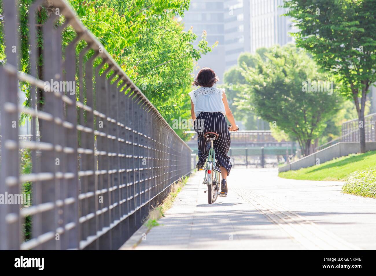 Woman riding a bicycle Stock Photo - Alamy