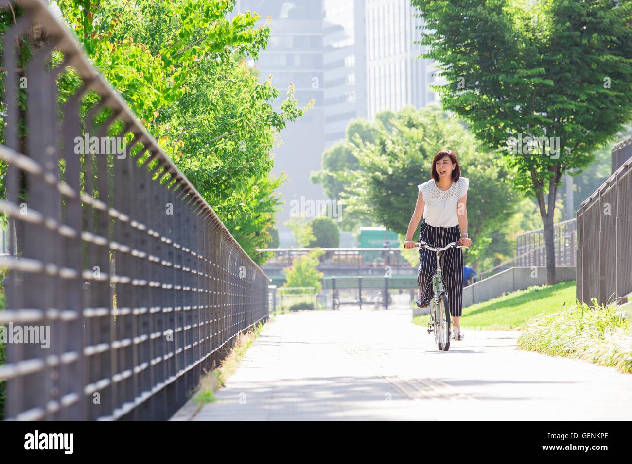 Woman riding a bicycle Stock Photo - Alamy
