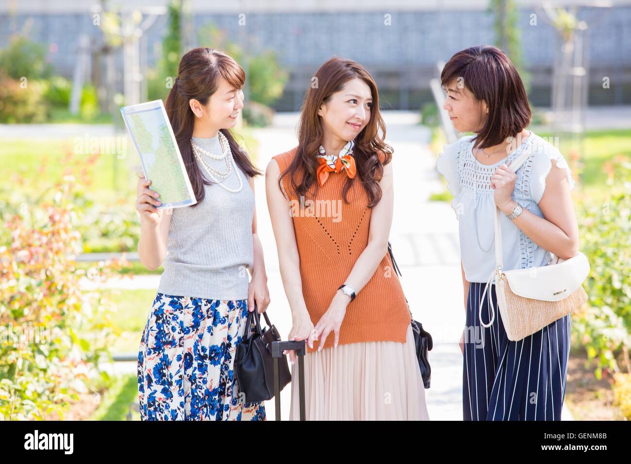 Women talking while seeing a map Stock Photo - Alamy