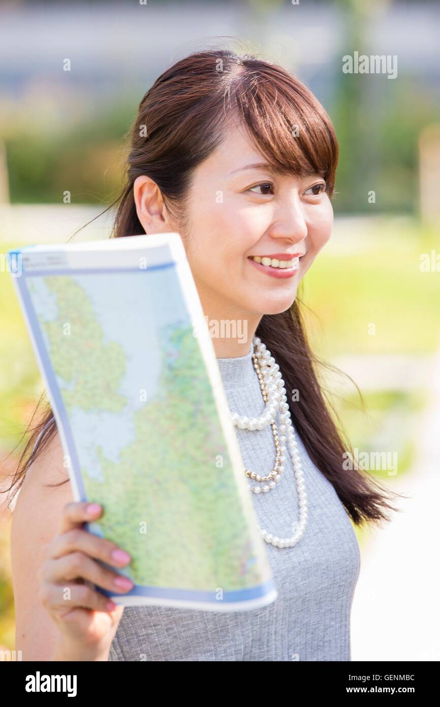 Woman with a map hi-res stock photography and images - Alamy