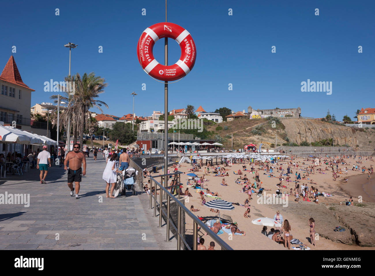 Vodafone advertising on the seafront pavement of sunbathers and walkers ...