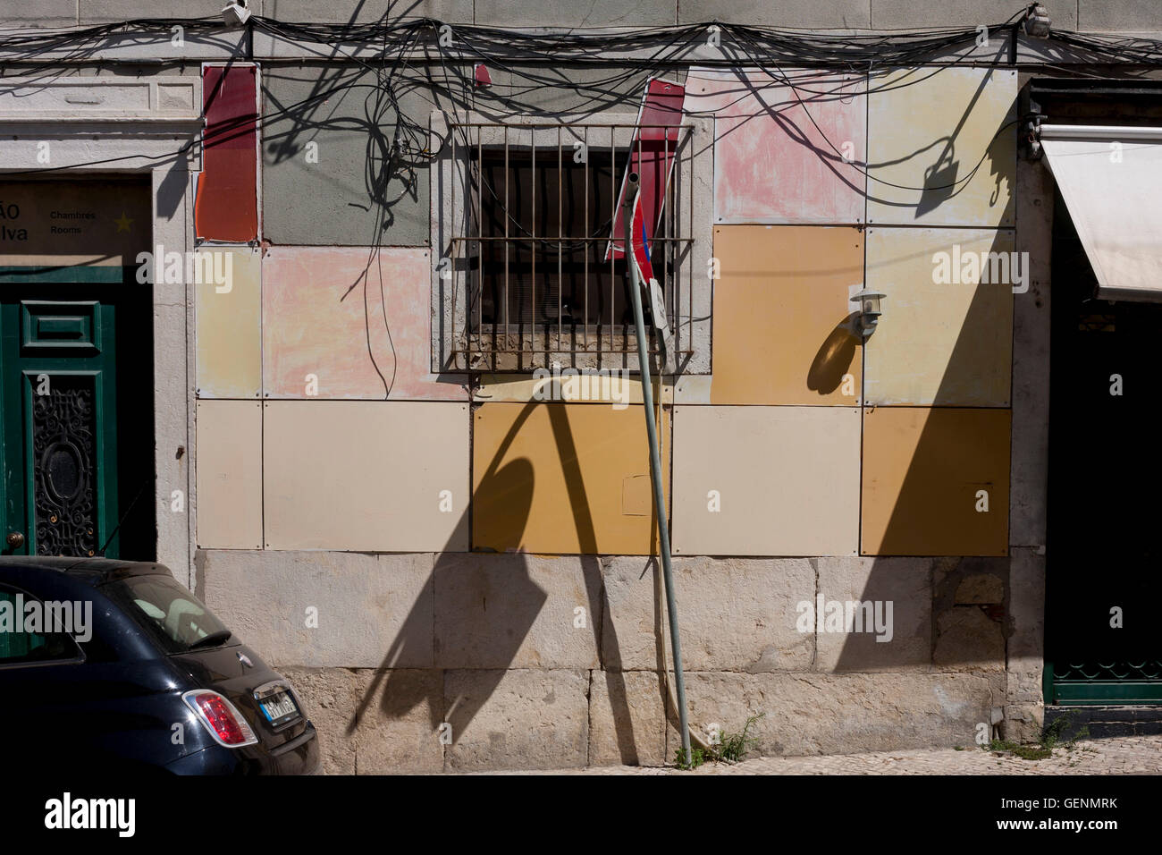 A tangle of confusing wires and cables and shadows on a house's ...