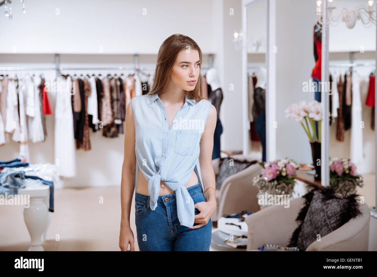 Attractive young woman walking and doing shopping in clothes shop Stock ...