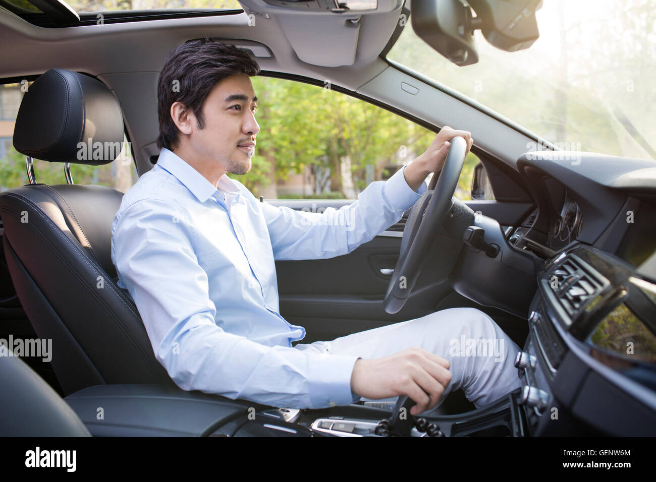 Young Chinese man driving car Stock Photo - Alamy