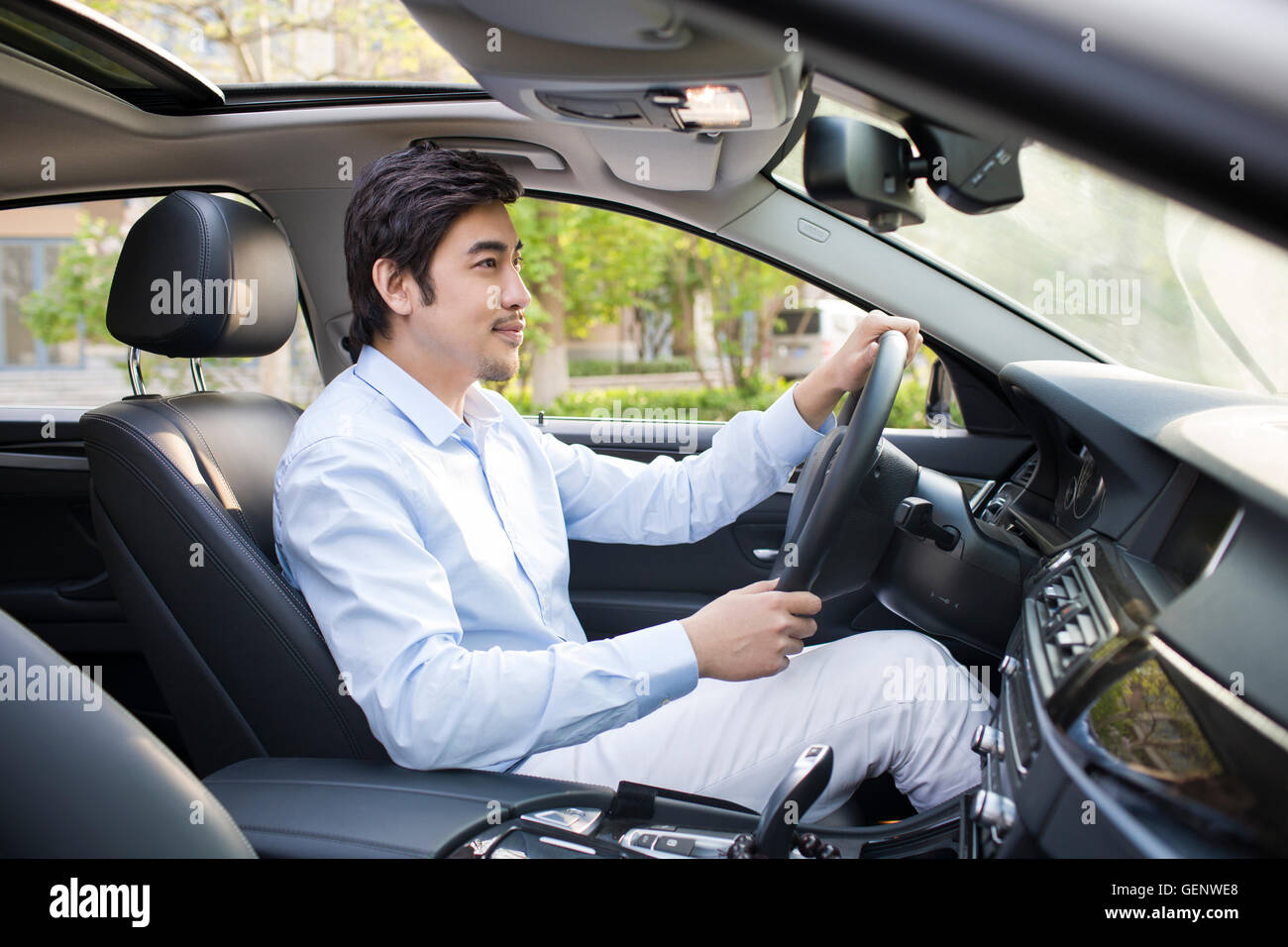Young Chinese man driving car Stock Photo - Alamy
