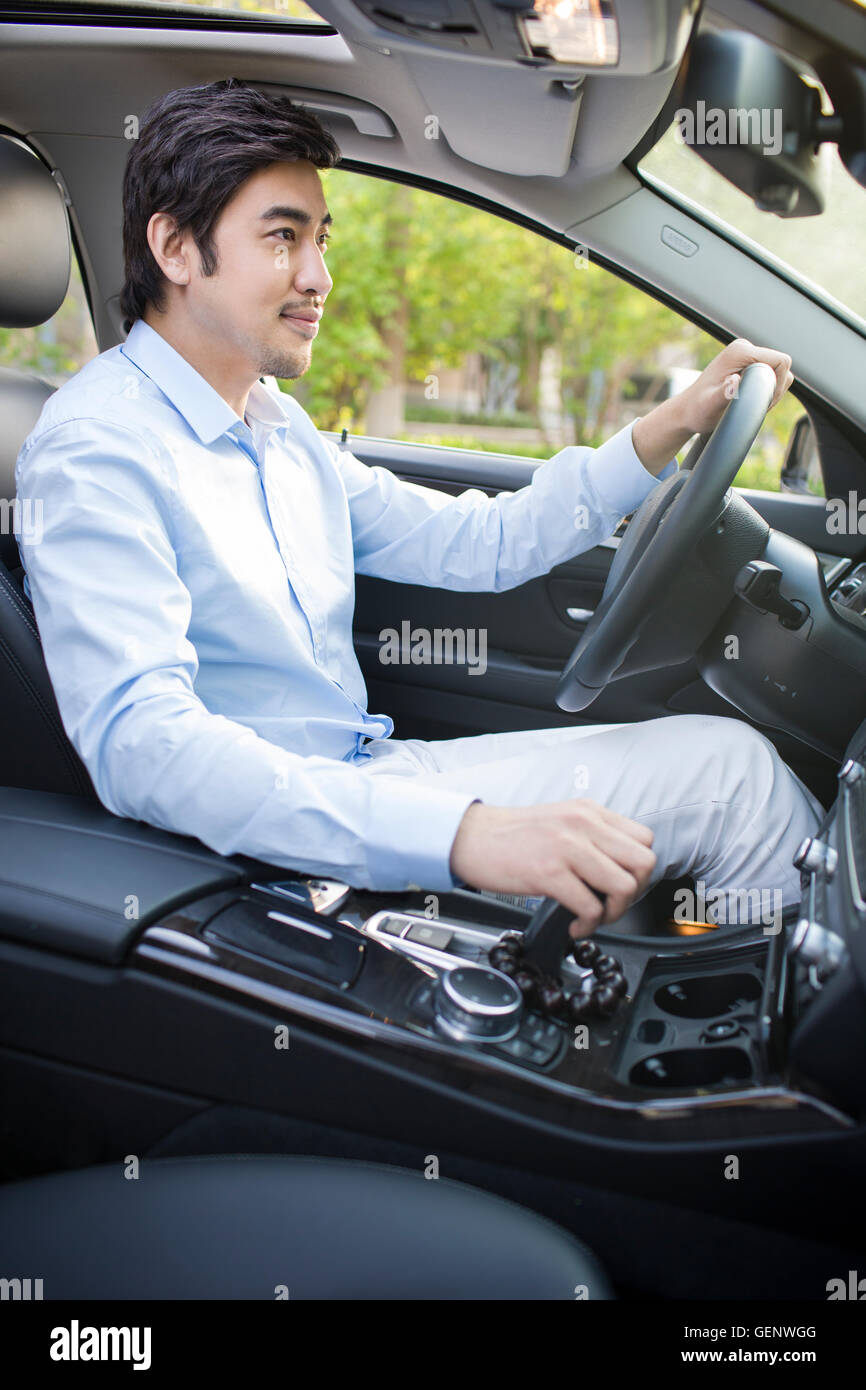 Young Chinese man driving car Stock Photo - Alamy