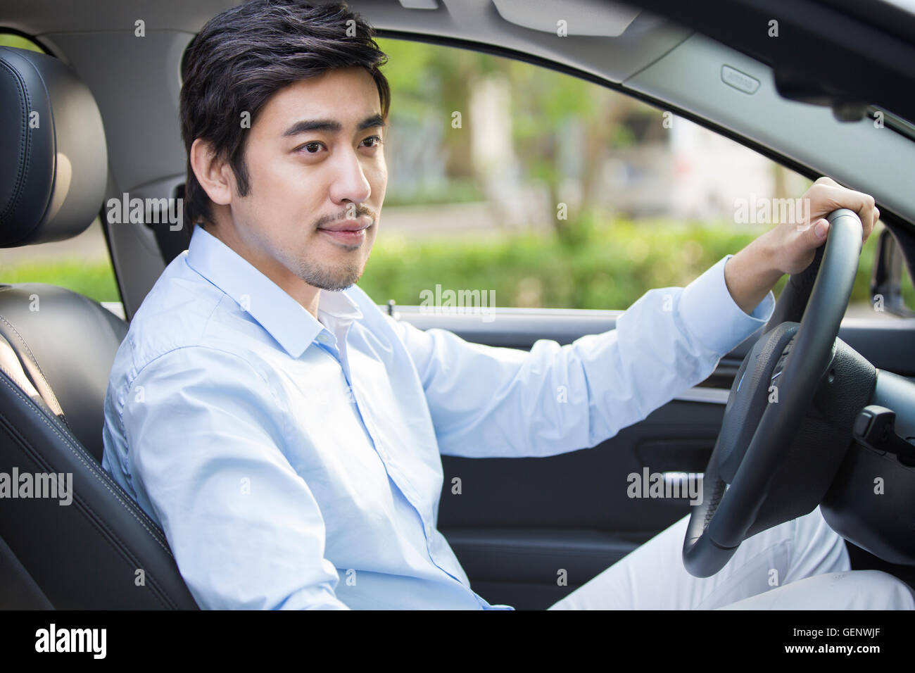 Young Chinese man driving car Stock Photo - Alamy