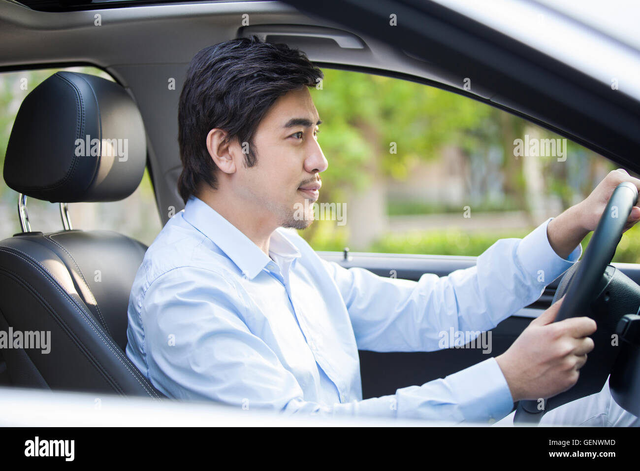 Young Chinese man driving car Stock Photo - Alamy