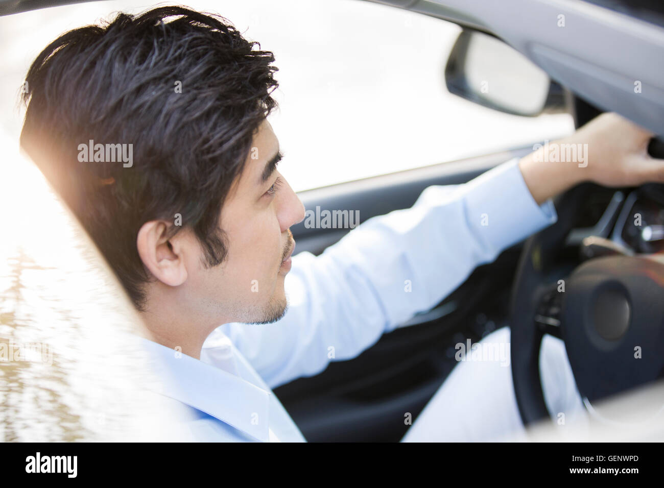 Young Chinese man driving car Stock Photo - Alamy