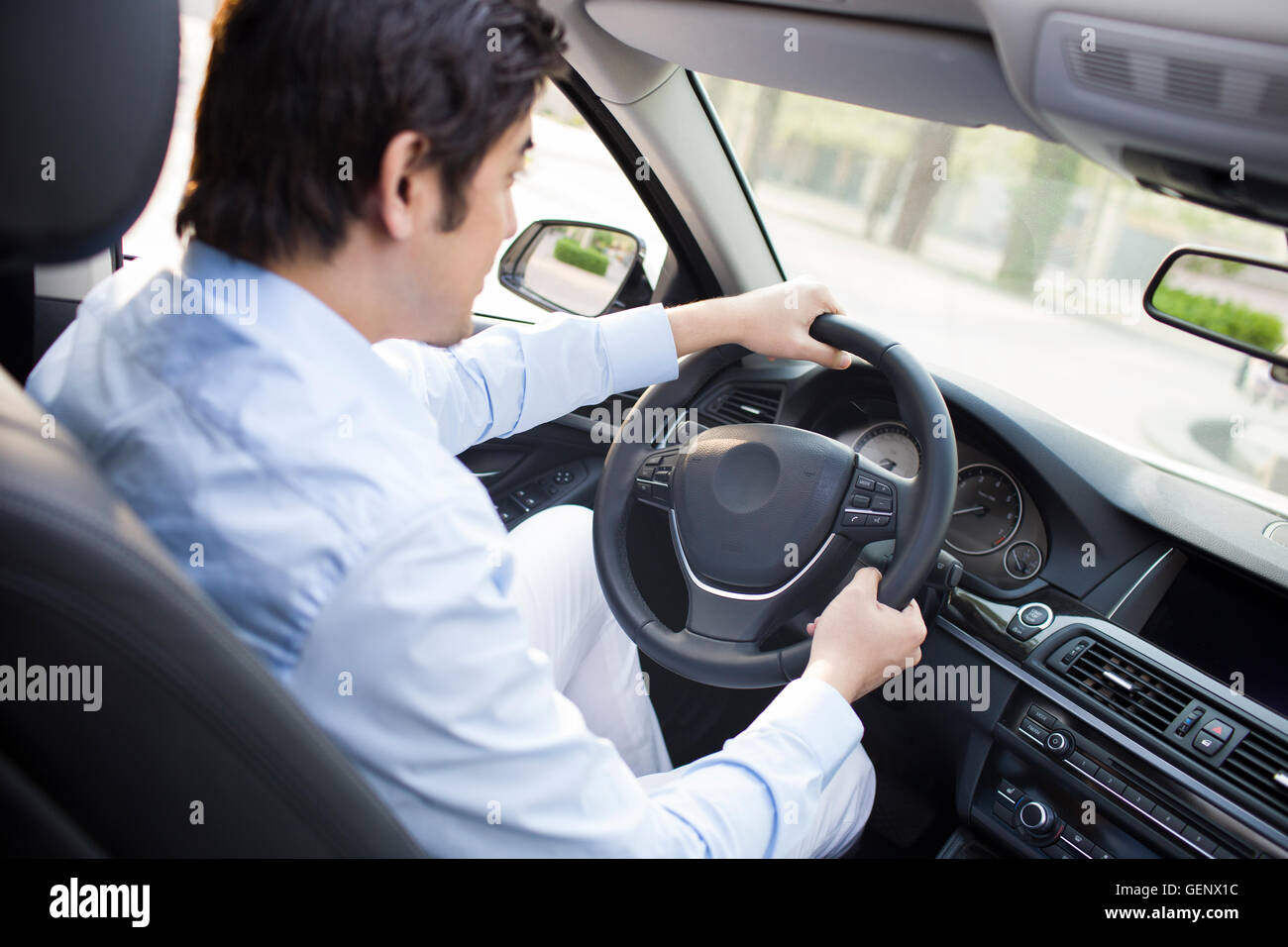 Young Chinese man driving car Stock Photo - Alamy