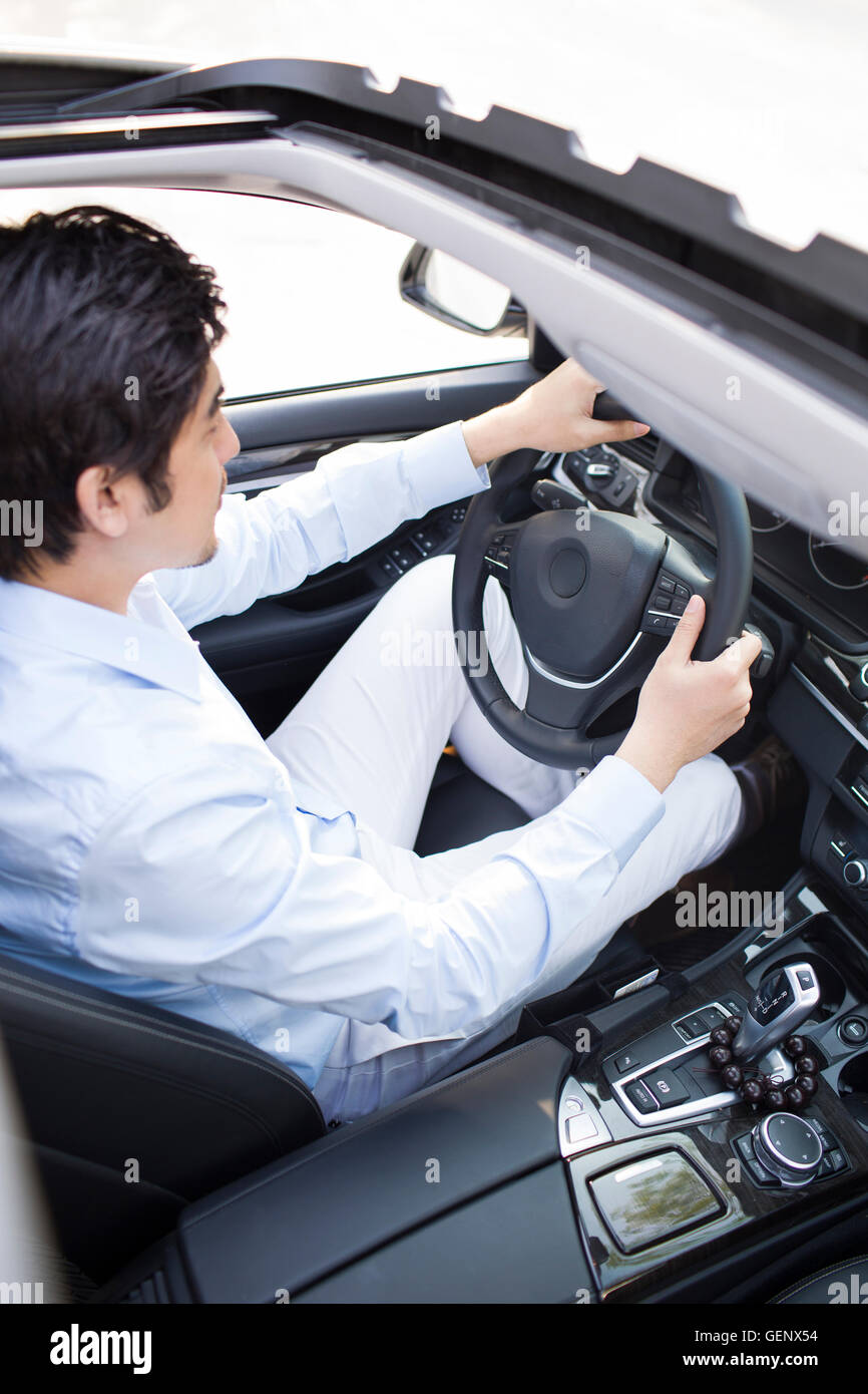 Young Chinese man driving car Stock Photo - Alamy