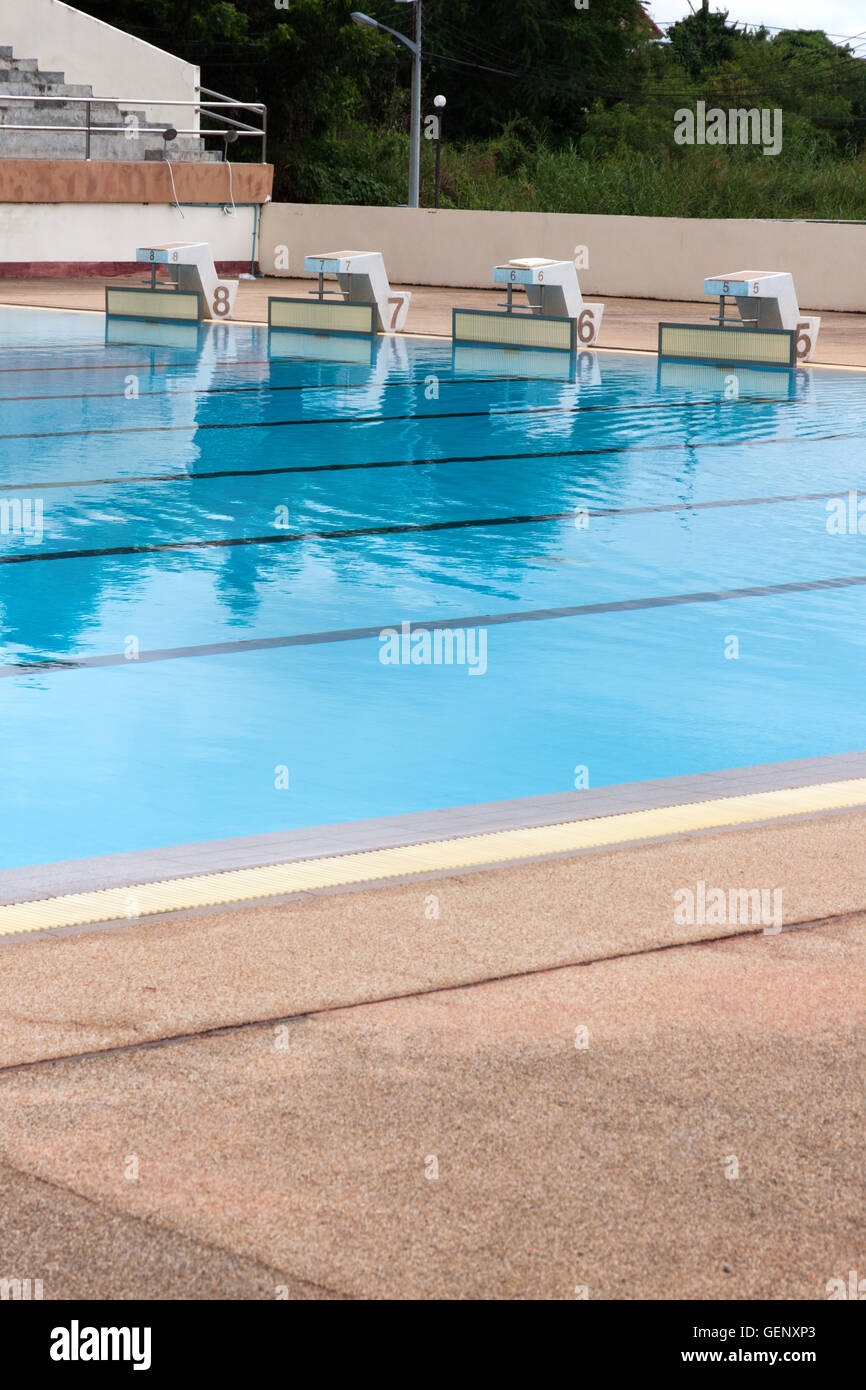 blue water wave in swimming pool reflects with sunlight , blue tile ...