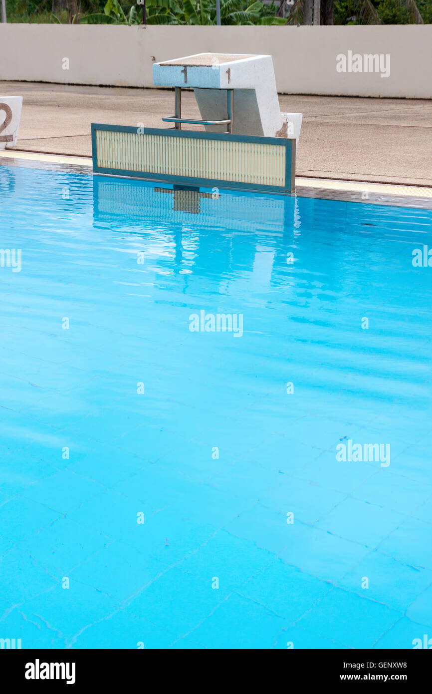 blue water wave in swimming pool reflects with sunlight , blue tile ...