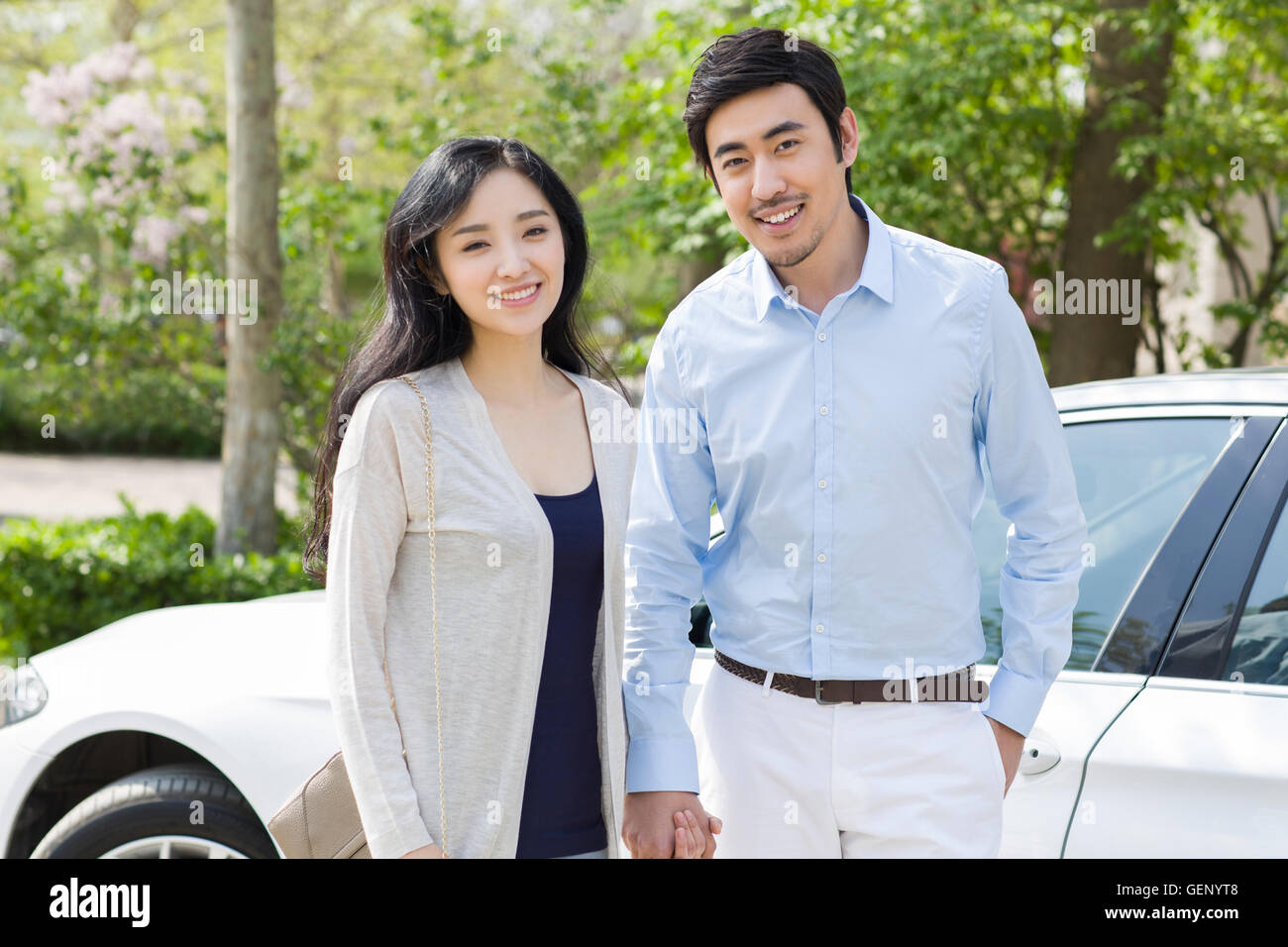 Happy young Chinese couple and car Stock Photo - Alamy