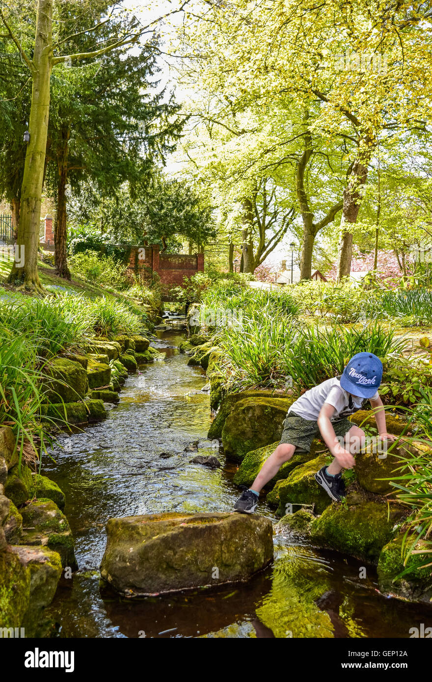 Child crossing a stream hi-res stock photography and images - Alamy