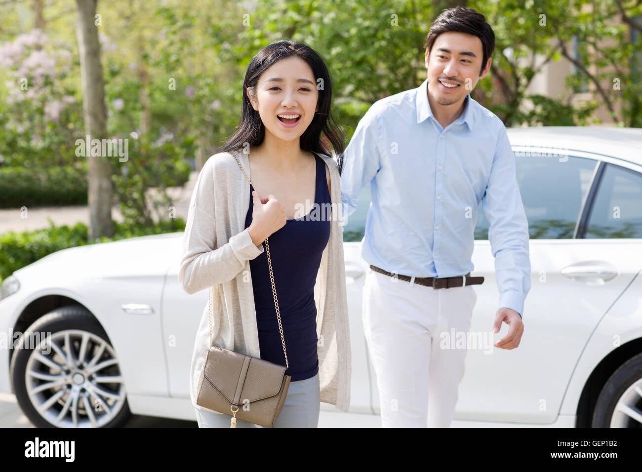 Happy young Chinese couple and car Stock Photo - Alamy
