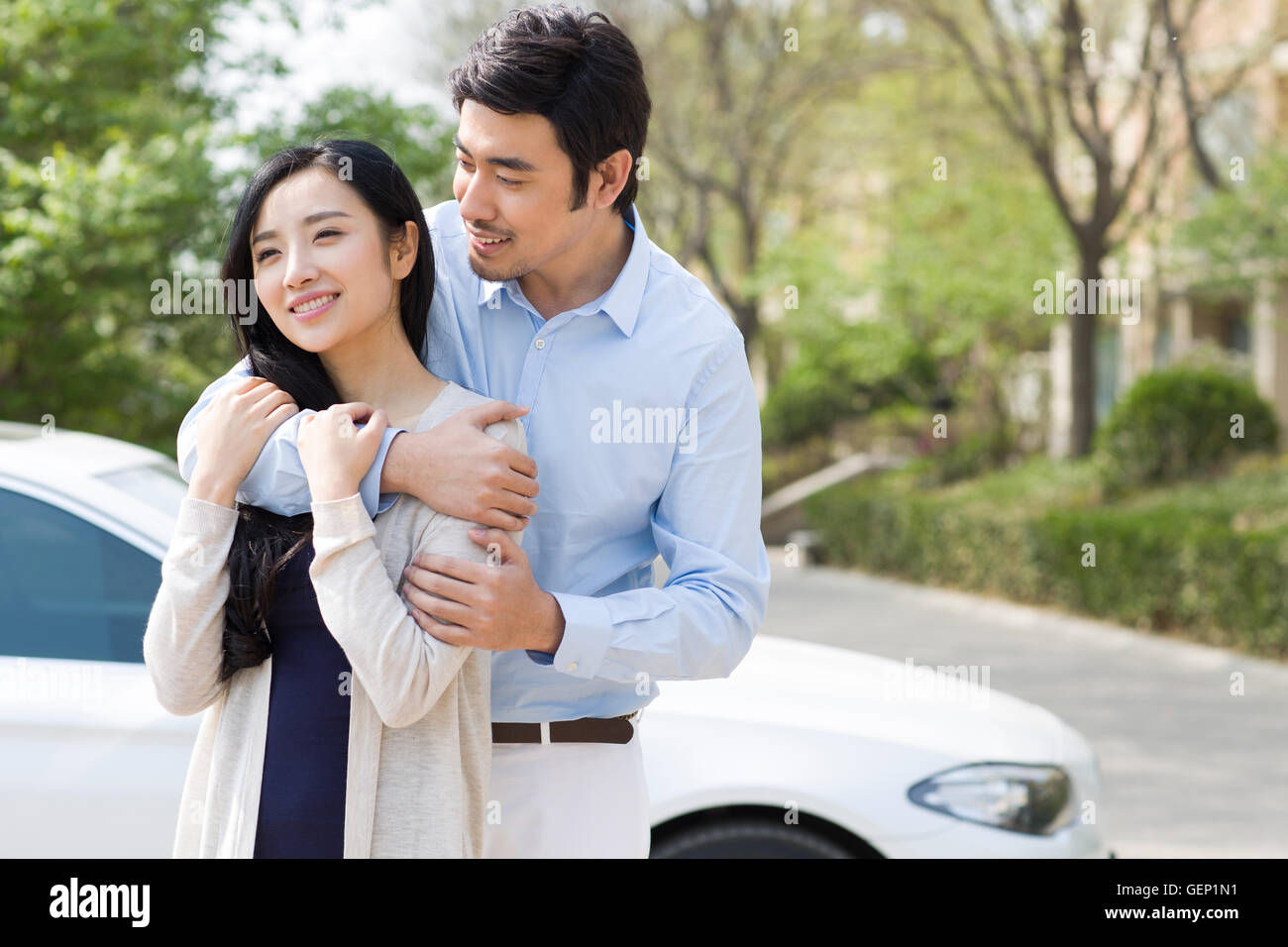 Happy young Chinese couple and car Stock Photo - Alamy