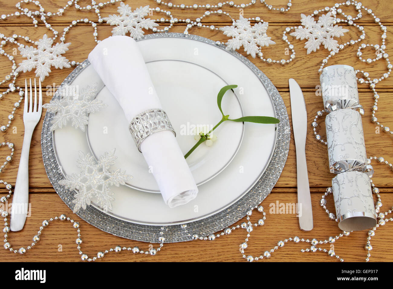 Sparkling christmas dinner table setting with white porcelain plates ...