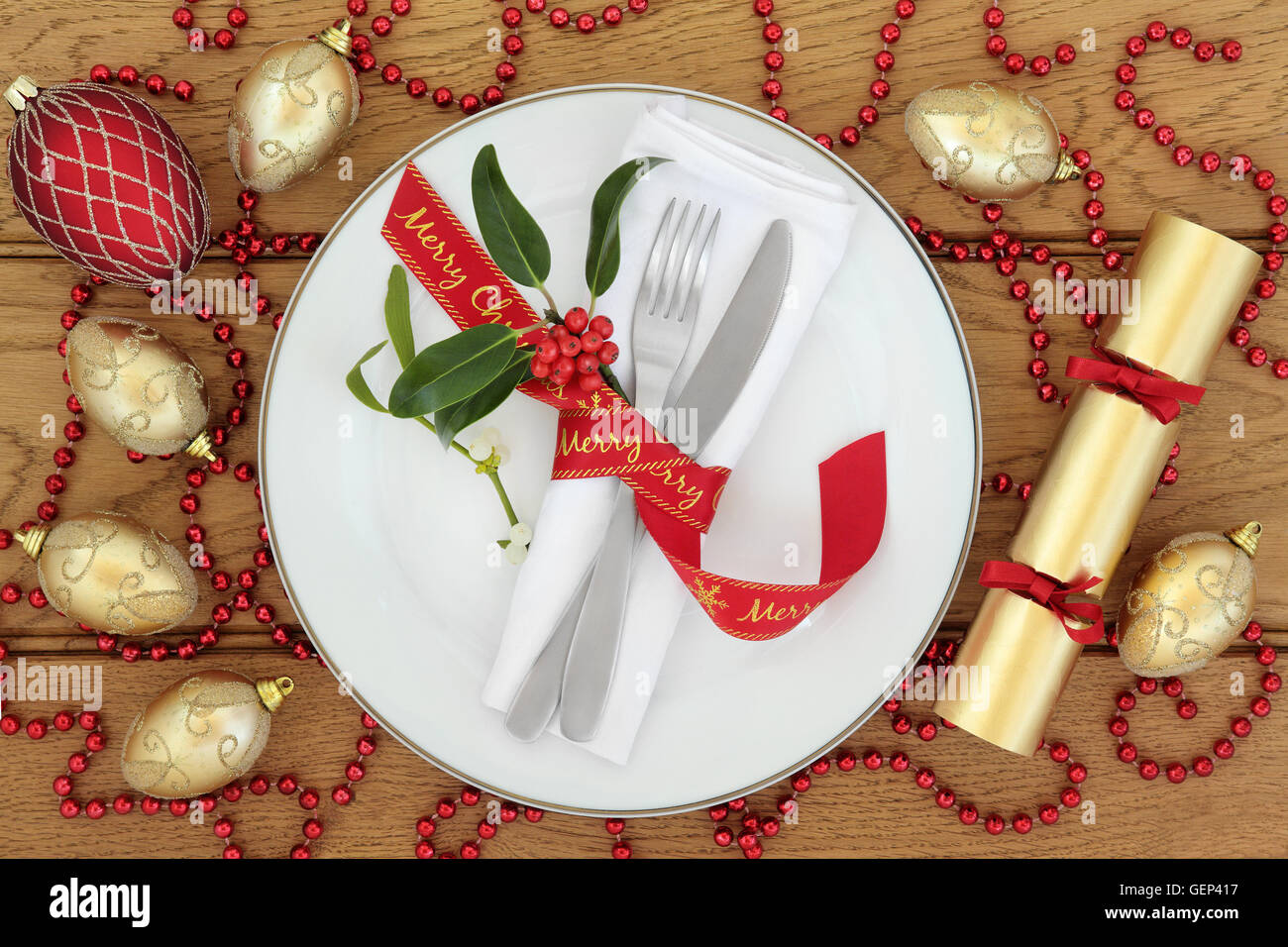 Christmas dinner table setting with white porcelain plate, red ribbon ...