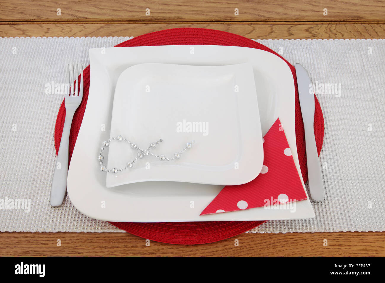 Elegant table setting with white porcelain plates, cutlery, decorative ...