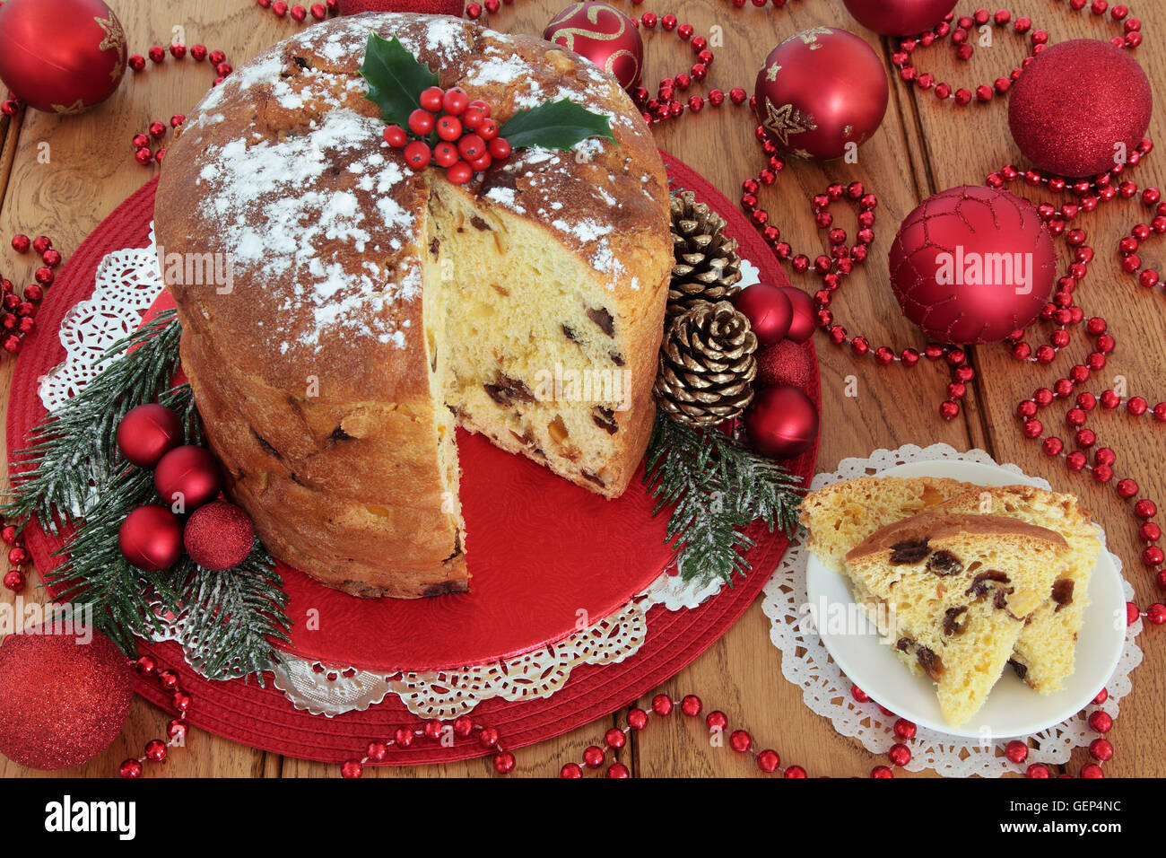 Traditional Italian panettone christmas cake and slice with holly ...