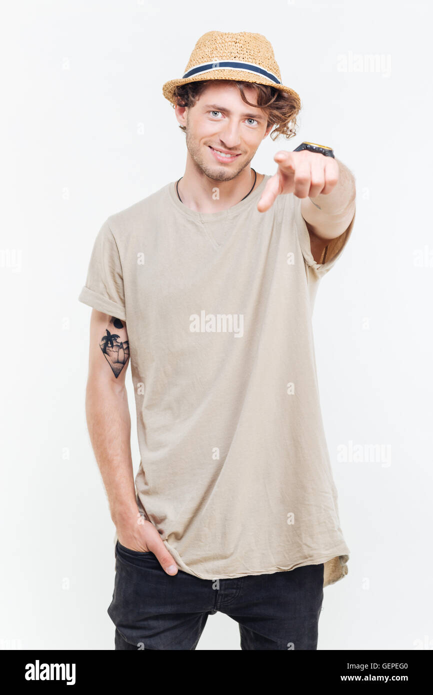 Full length portrait of a young casual man pointing finger at camera ...